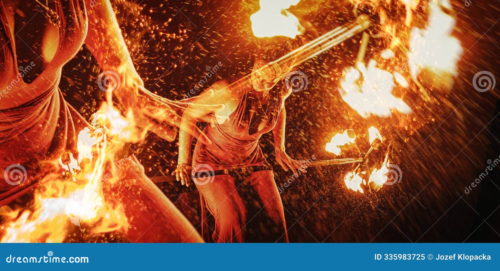 An Enchanting Fire Dancer Beautifully Showcases Her Talent with Mesmerizing Flames during a ...