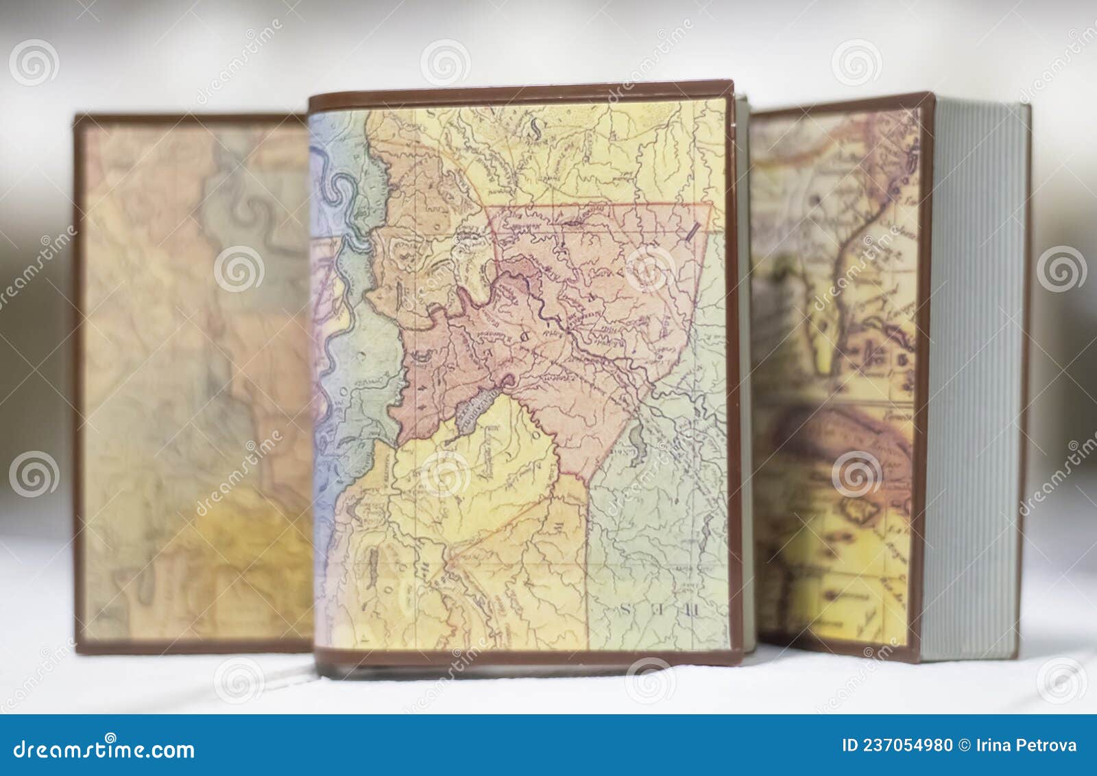 Encyclopedic Books with World Maps on a White Wooden Background Stock ...