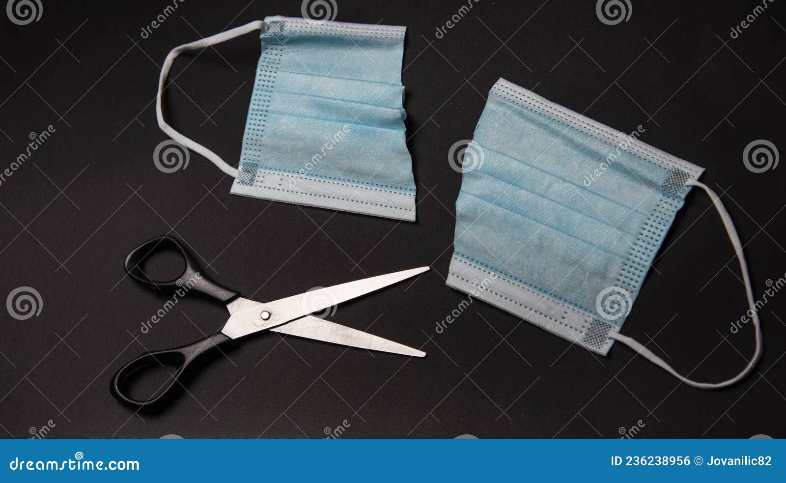 End of the Covid 19 Pandemic. Scissors Cut the Face Mask Stock Photo ...