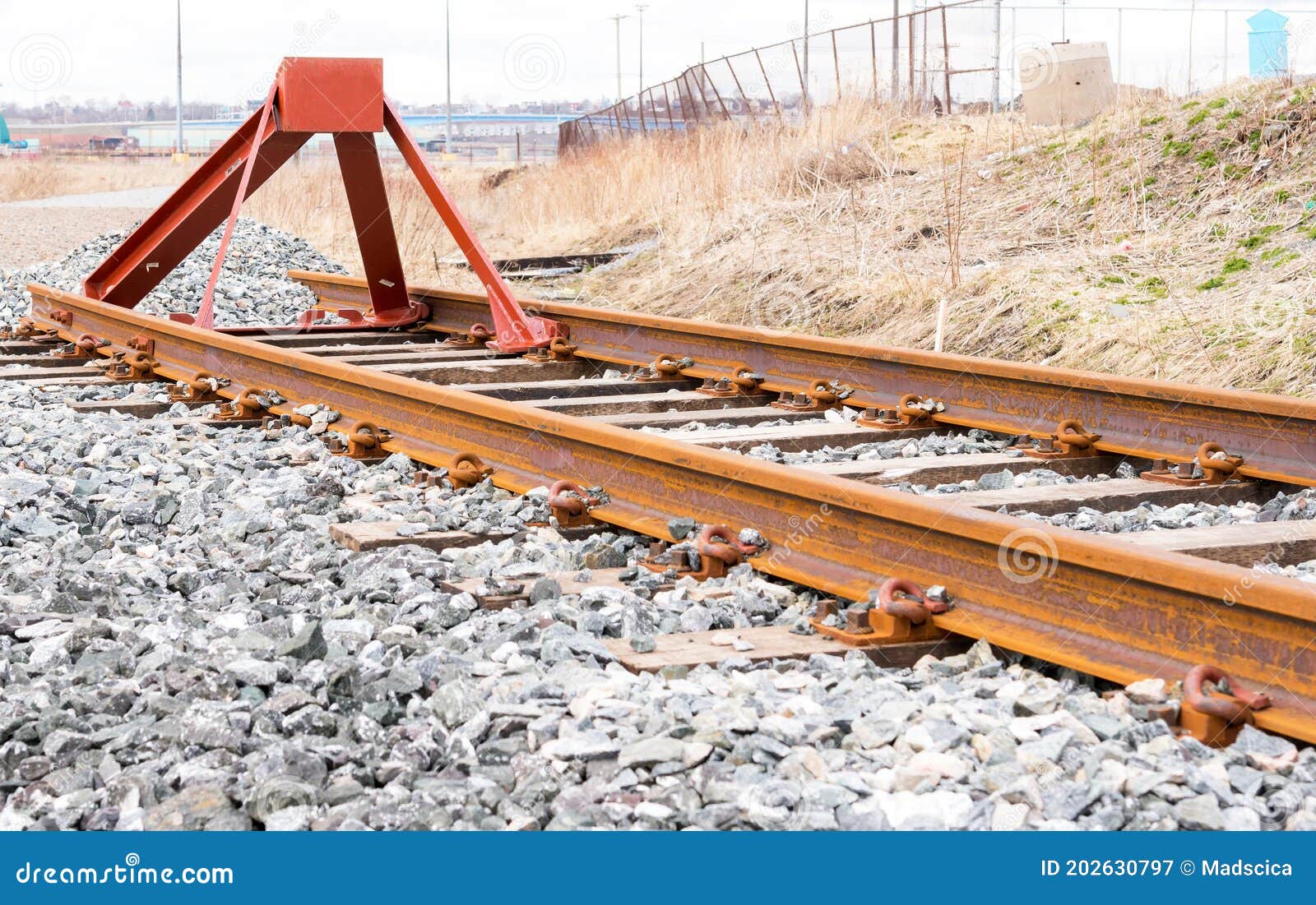 A Red Railway Stopper the the End of Some Old, Rusty Train Tracks Stock ...