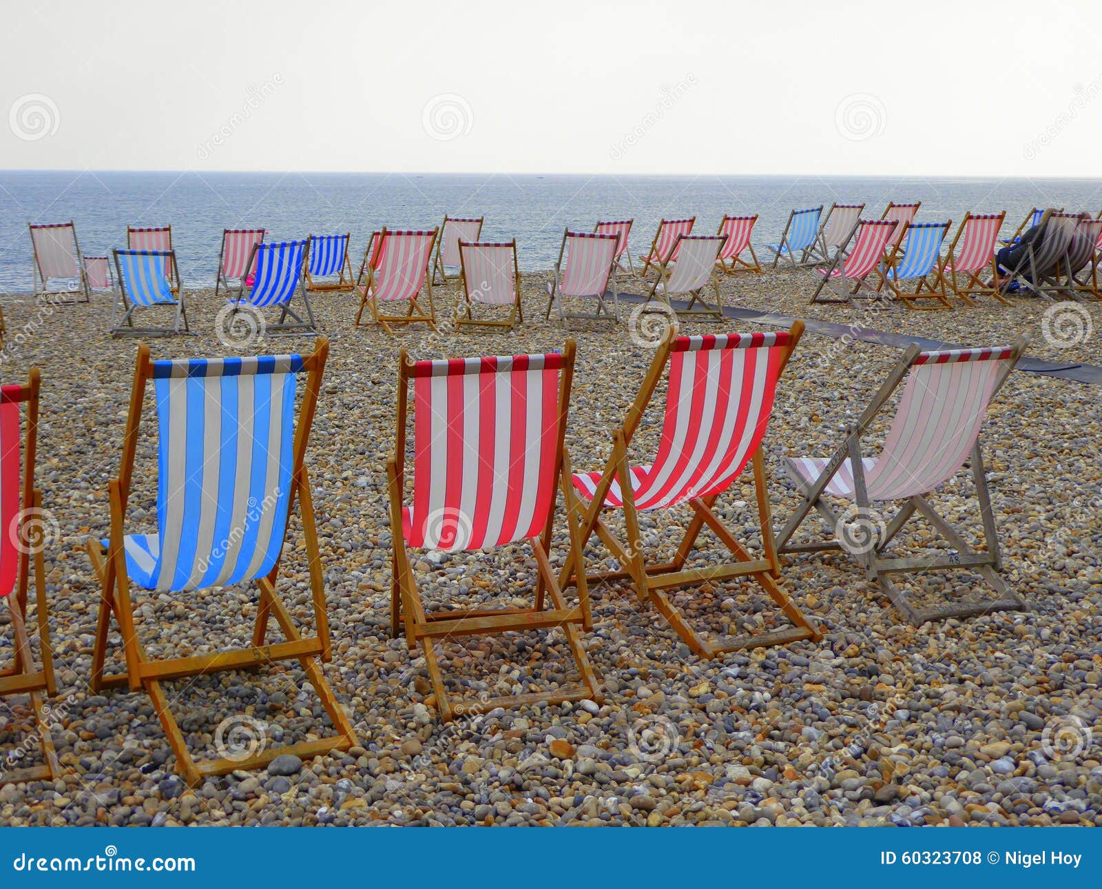 Empty deck chairs on beach stock photo. Image of collapsible - 60323708