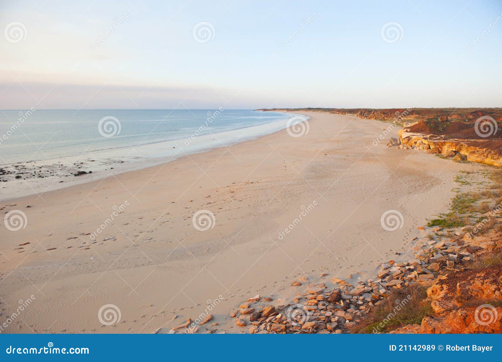 Endless Beach with Red Rock Formation Stock Image - Image of ocean ...