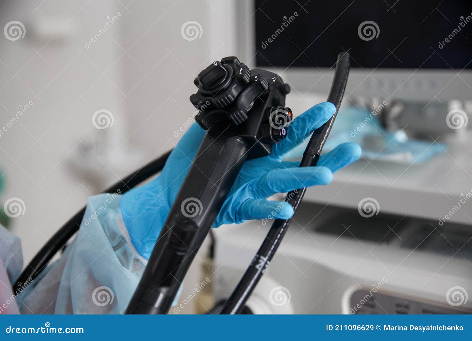 An Endoscopist in Blue Gloves Holds an Endoscope in His Hands. in the ...