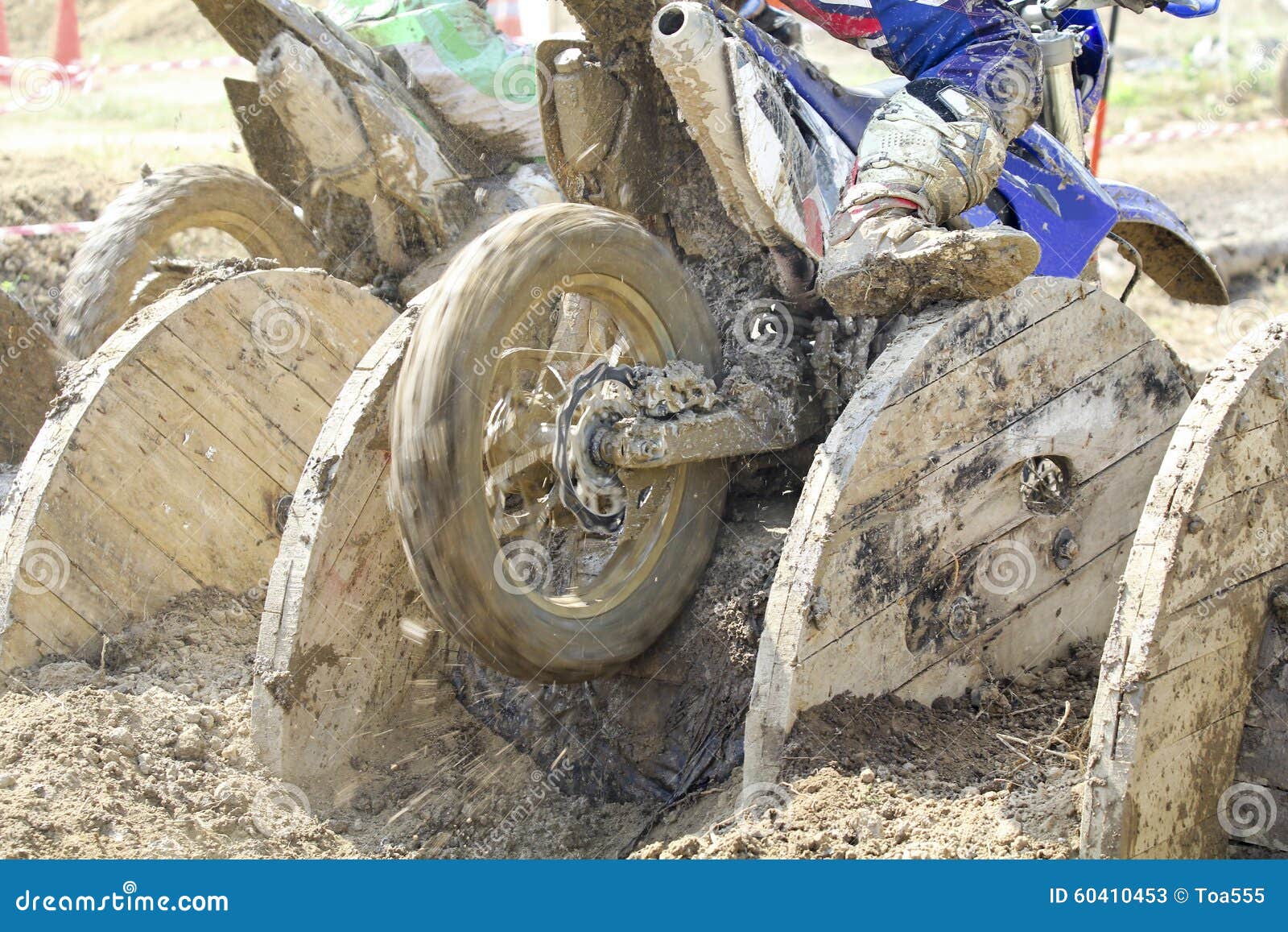 Enduro Bikes Pass Obstacle Cable Drums in Track. Stock Image - Image of ...