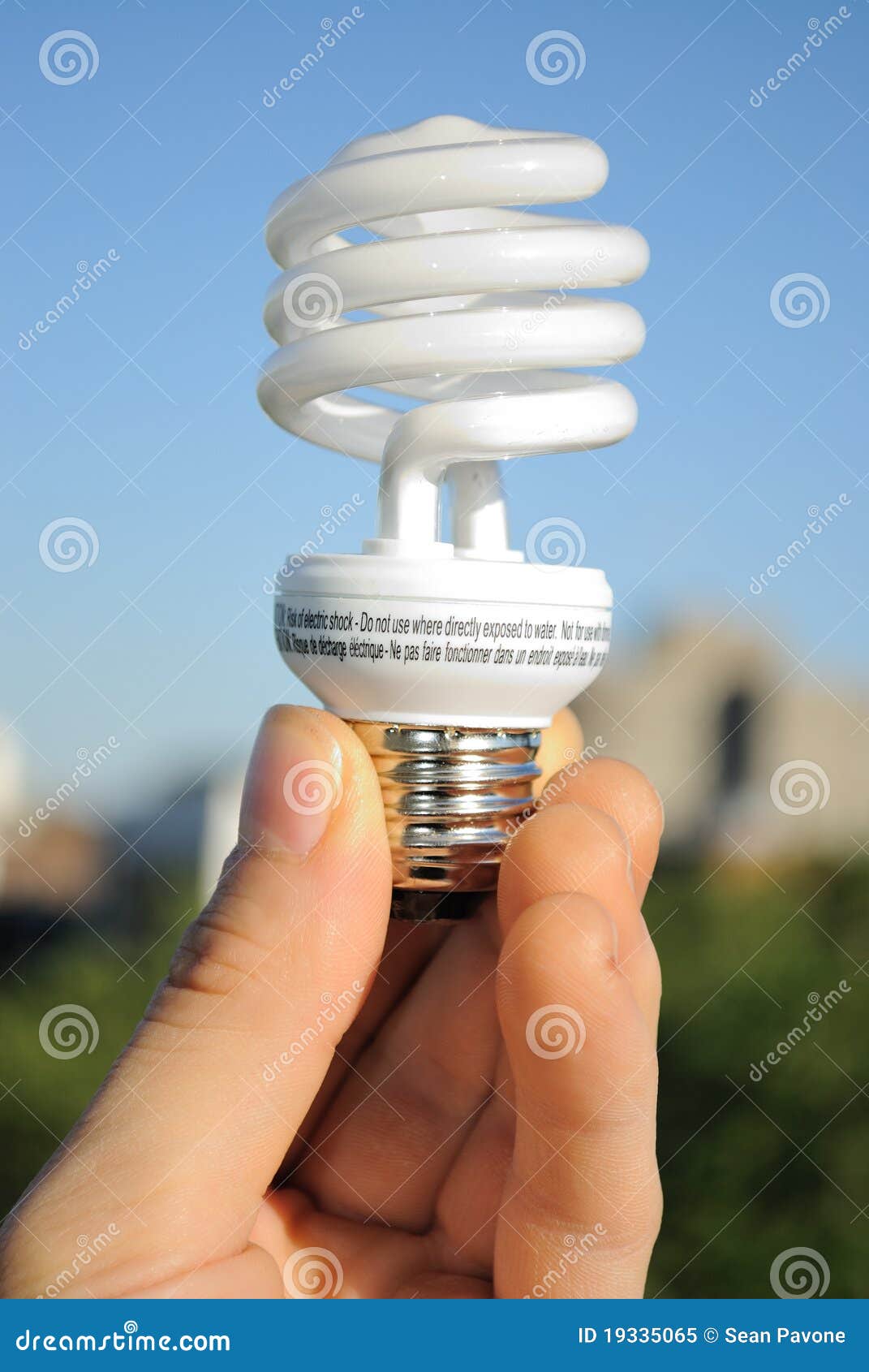 Energy Efficient Light Bulb Stock Image - Image of amps, fingers: 19335065