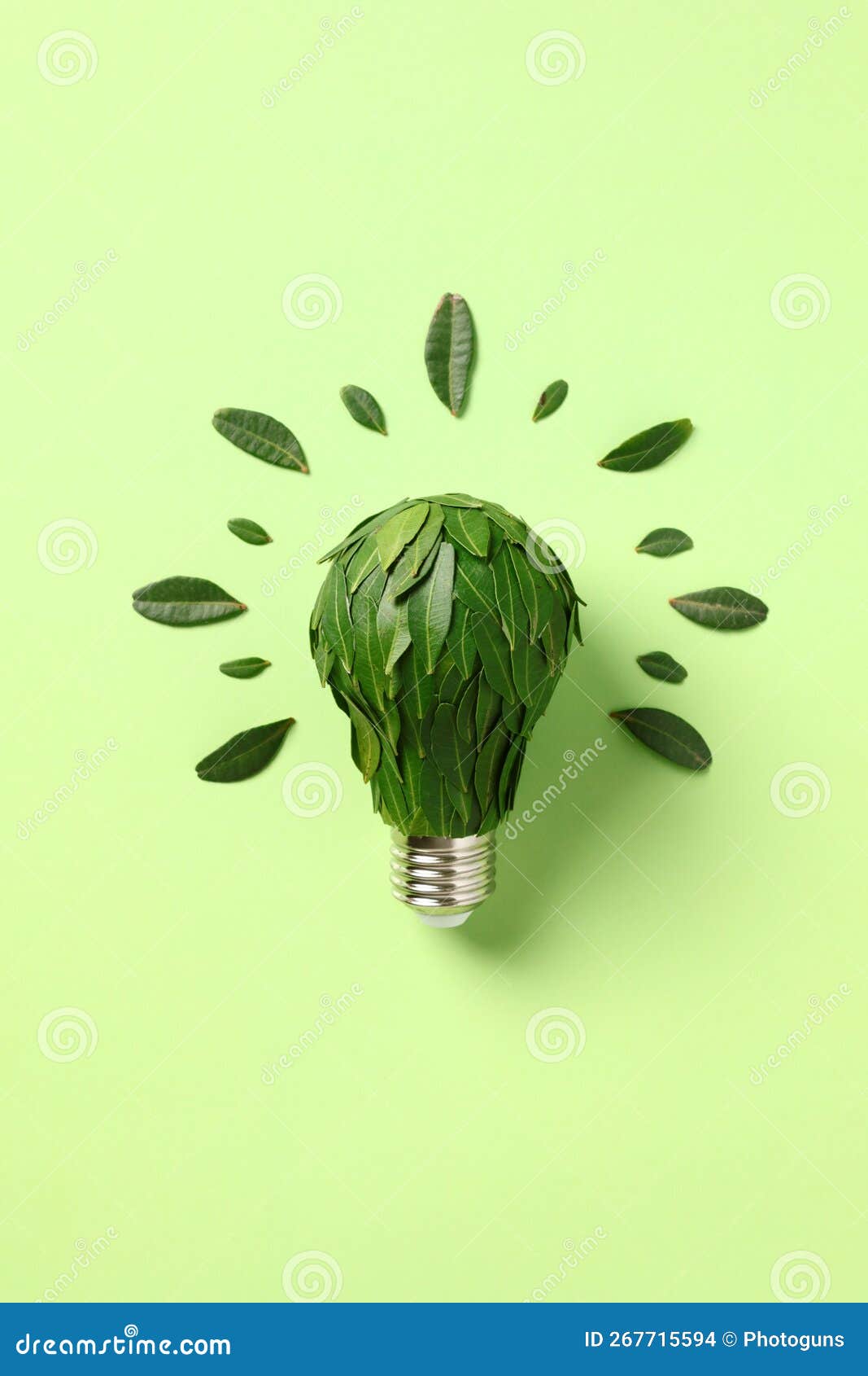 Energy Efficient Light Bulb with Green Leaves on Green Background ...