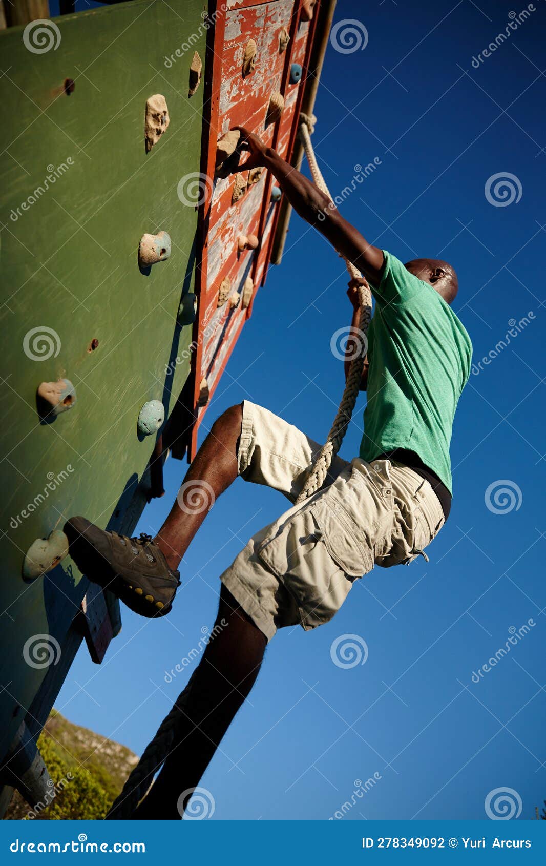 Energy and Persistence Conquer All Things. a Young Man Climbing Over an ...