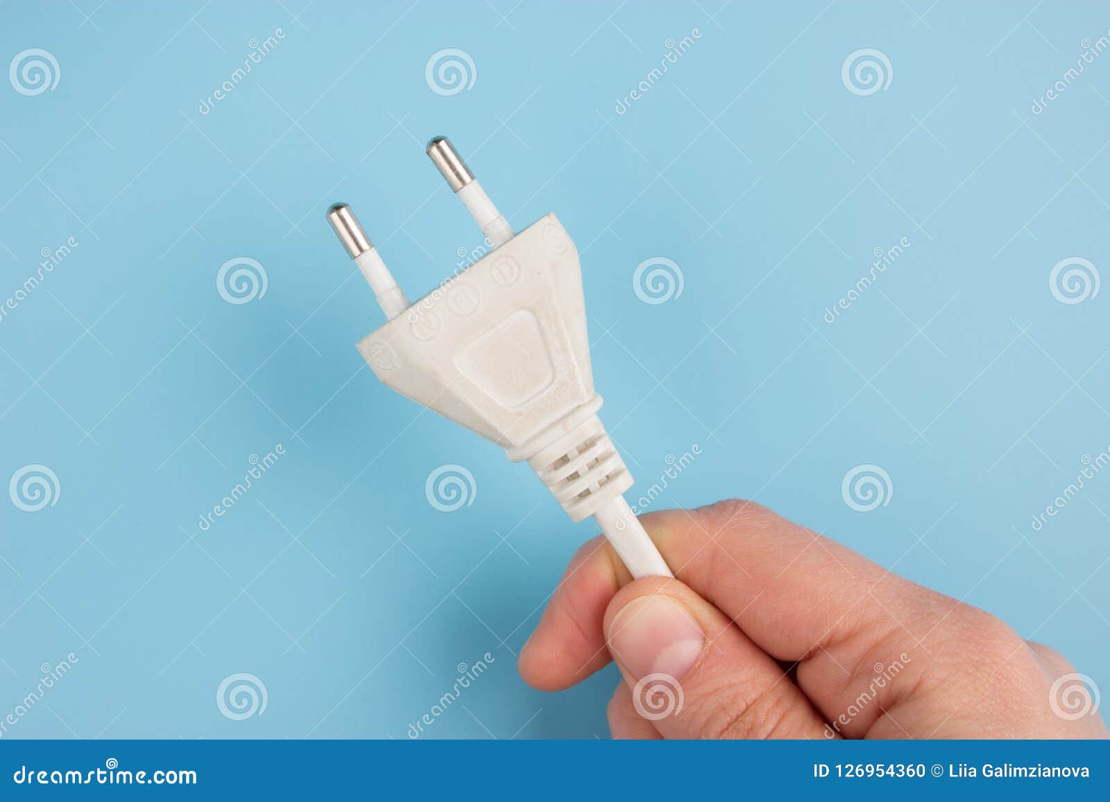 Energy Saving Concept. Electrical Plug on Blue Background Stock Photo ...