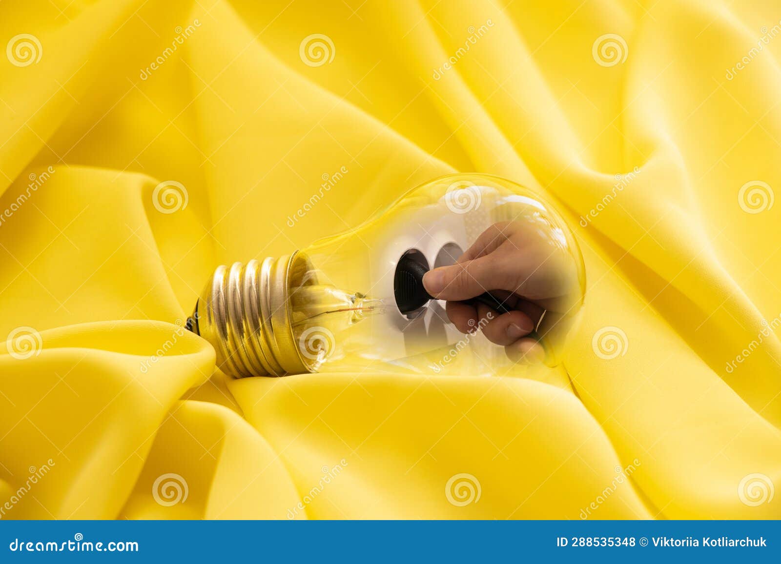 Energy-saving Light Bulb and Inside the Light Bulb, the Hand Inserts ...