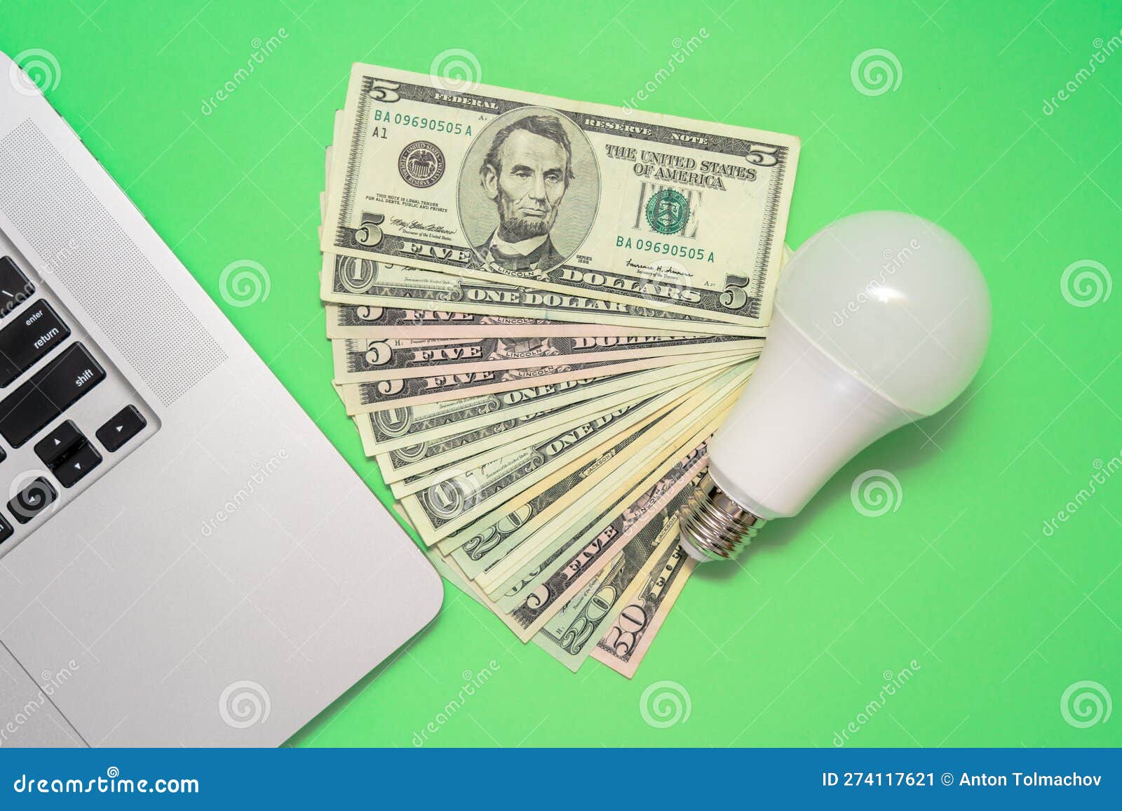 Energy Saving Light Bulb with Money and Laptop. Savings Stock Image ...