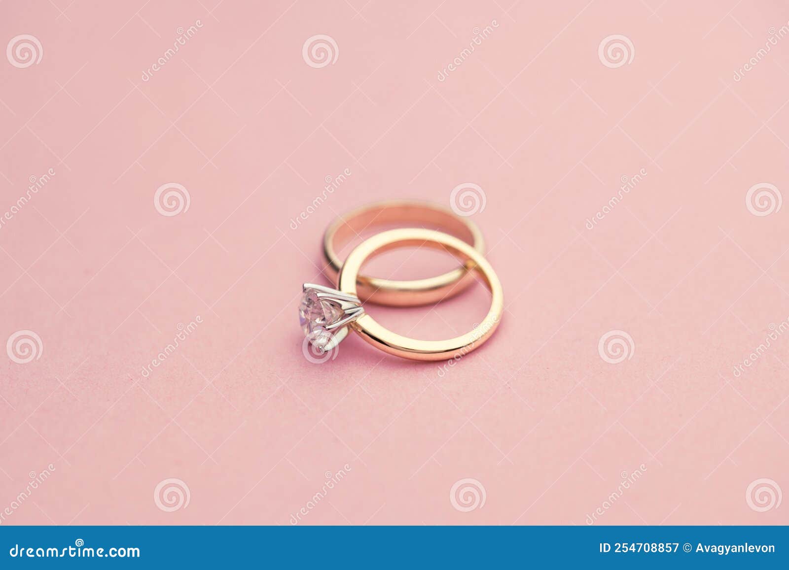 Engagement and Wedding Rings on Pink Background Stock Image - Image of ...
