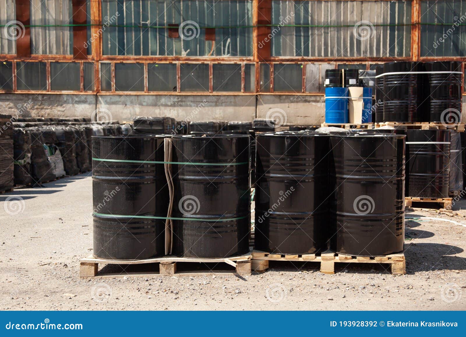 Engine Oil in Black Barrels are Stored in Several Rows in the Warehouse ...