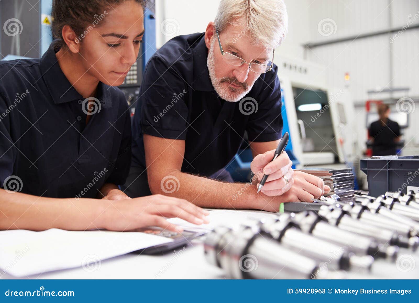 Engineer and Apprentice Planning CNC Machinery Project Stock Photo ...