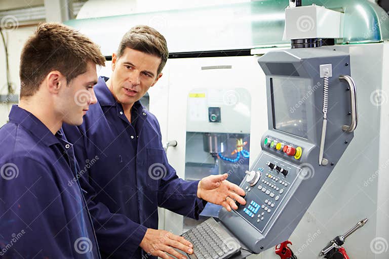 Engineer and Apprentice Using Automated Milling Machine Stock Photo ...