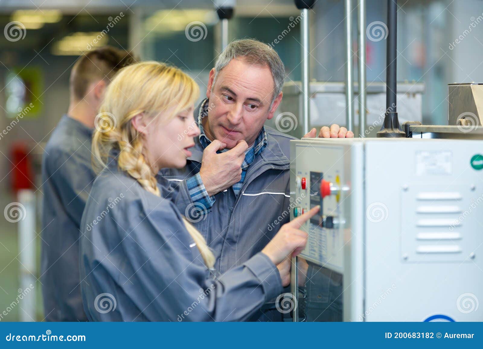 Engineer and Apprentice Using Computerized Cutting Machine Stock Photo ...