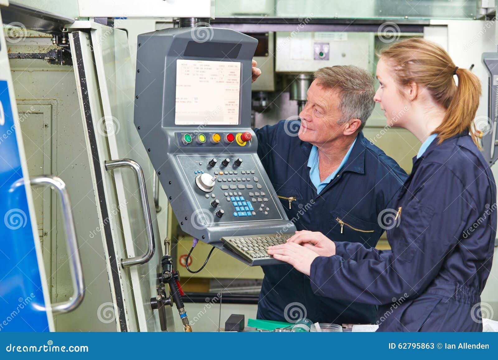 Engineer and Apprentice Using Computerized Cutting Machine Stock Image ...