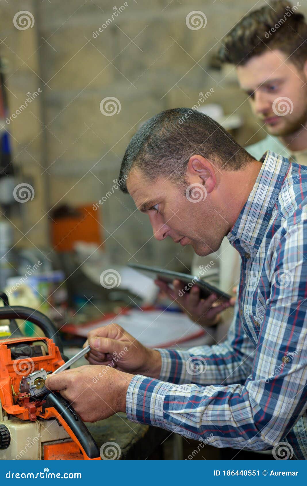Engineer and Apprentice Working on Machine in Factory Stock Image ...