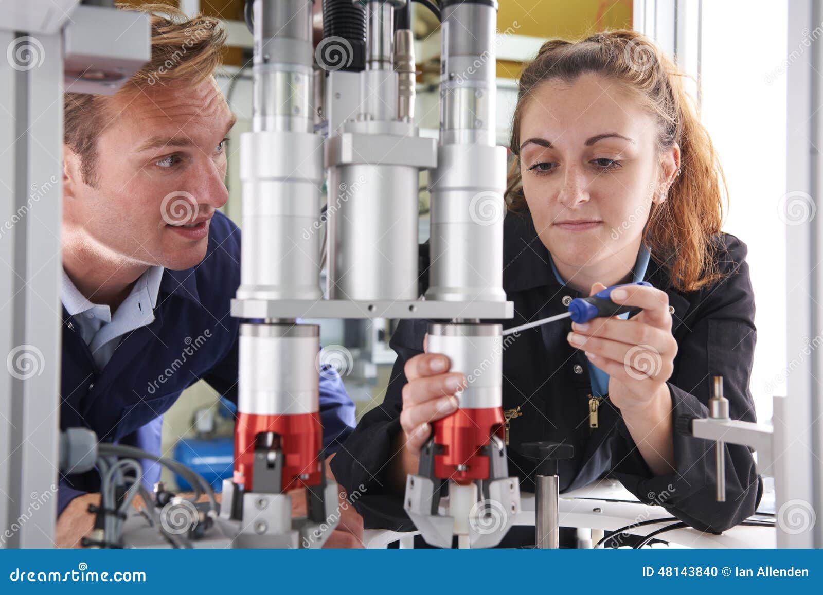 Engineer and Apprentice Working on Machine in Factory Stock Photo ...