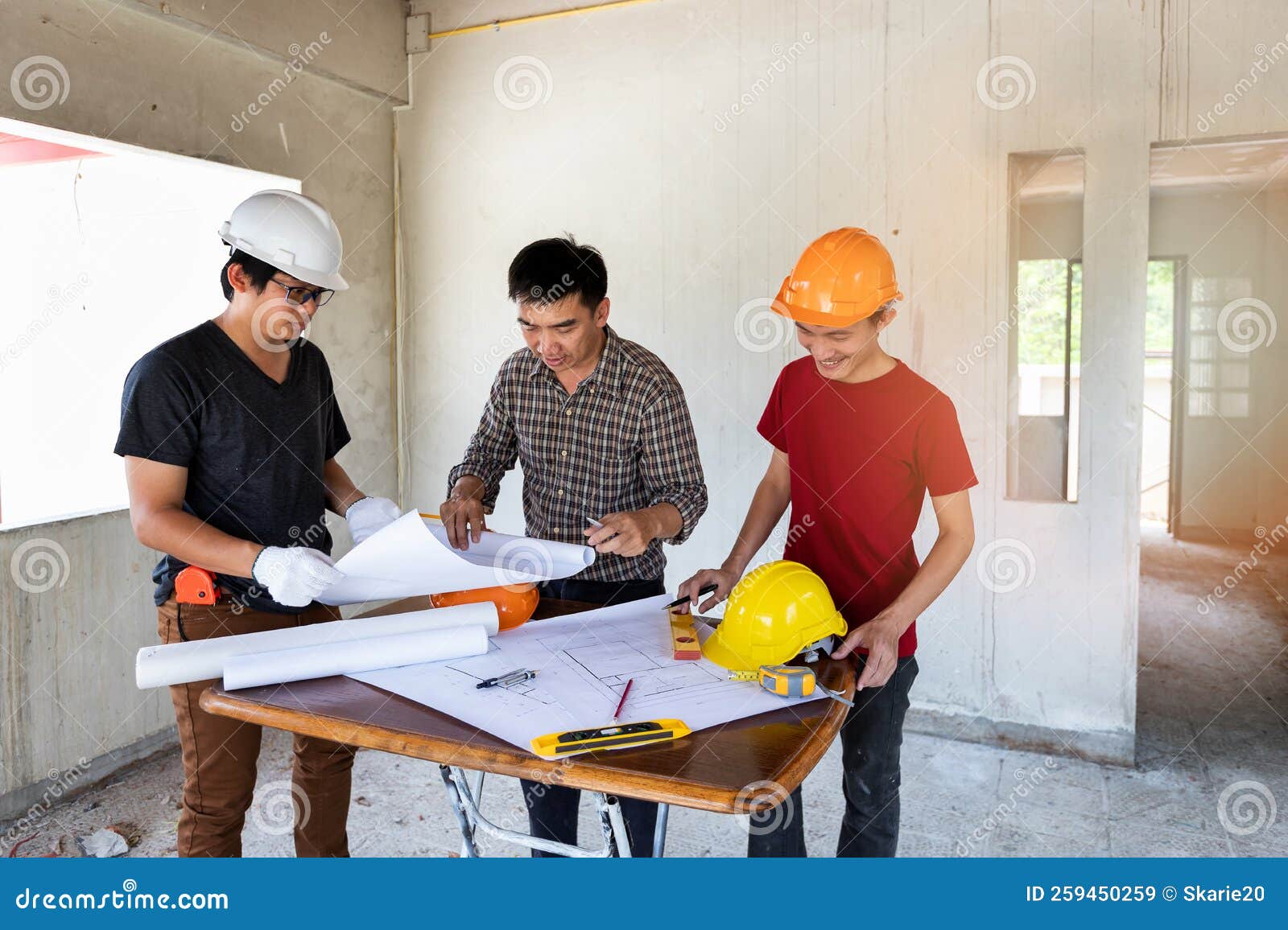 Engineer and Architect Discussing with Foreman about Project in ...