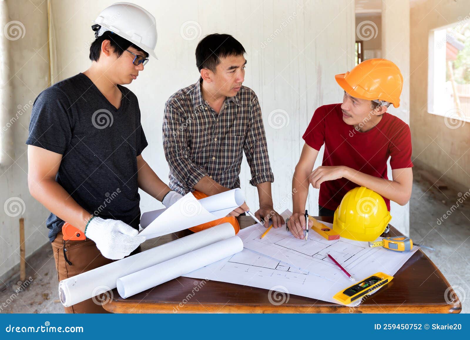 Engineer and Architect Discussing with Foreman about Project in ...