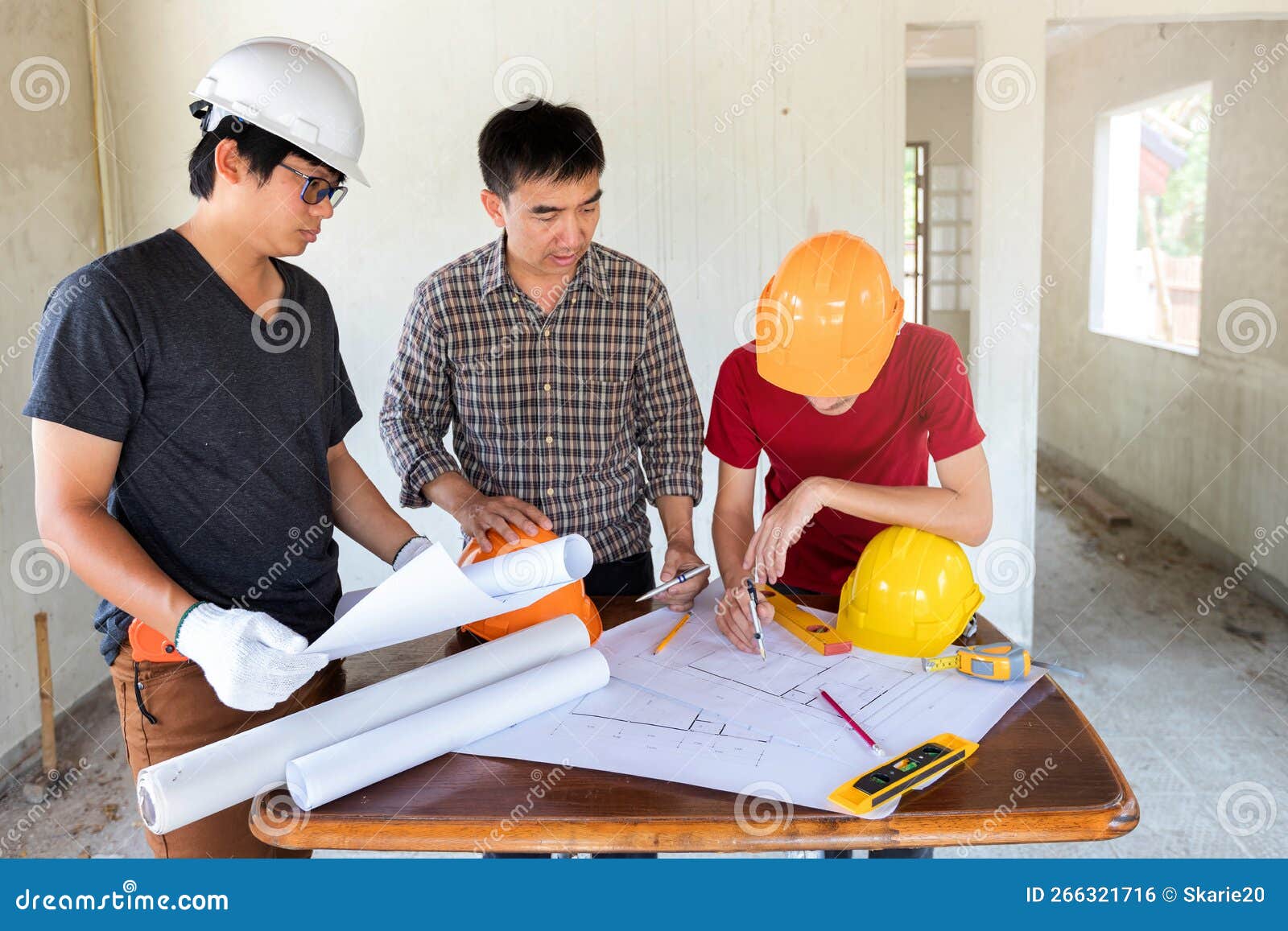 Engineer and Architect Discussing with Foreman about Project in ...