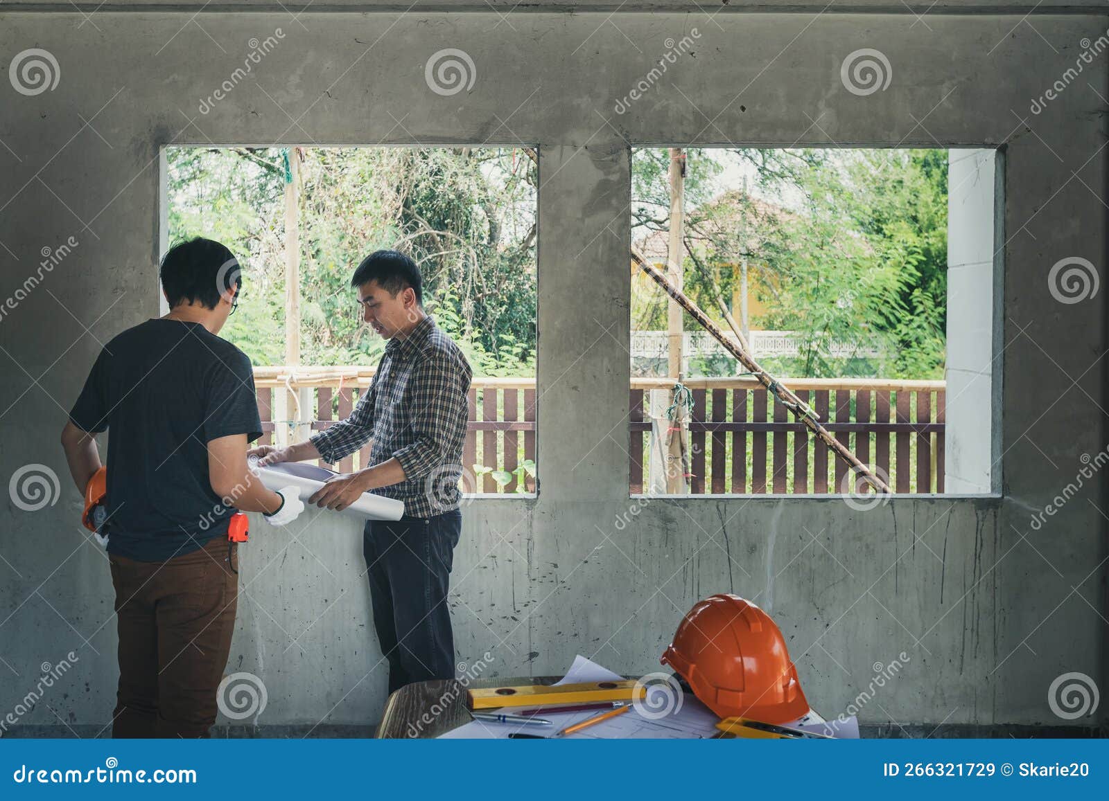 Engineer and Architect Discussing with Foreman about Project in ...