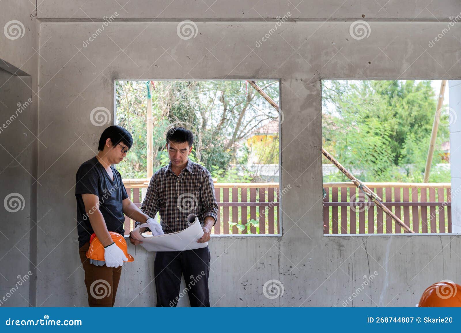 Engineer and Architect Discussing with Foreman about Project in ...