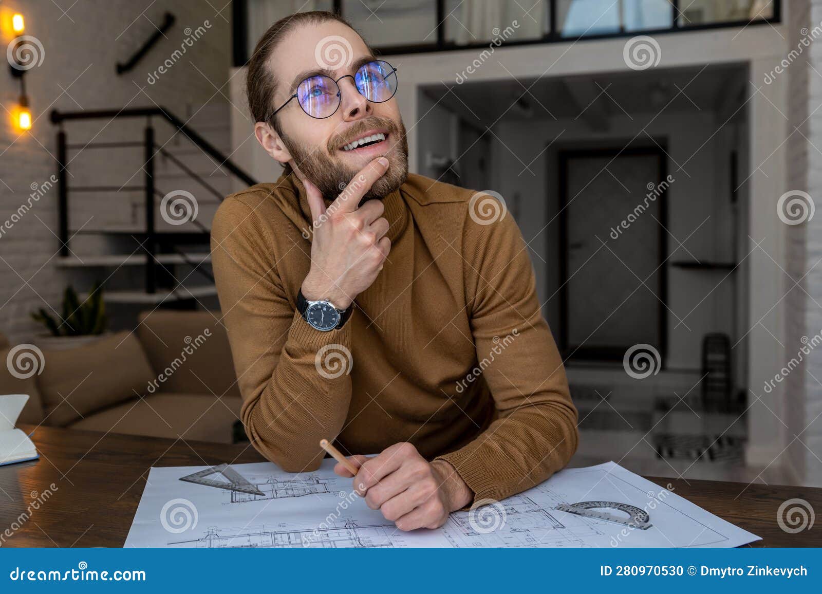 Engineer Architect in Glasses Sitting at the Table and Creating ...