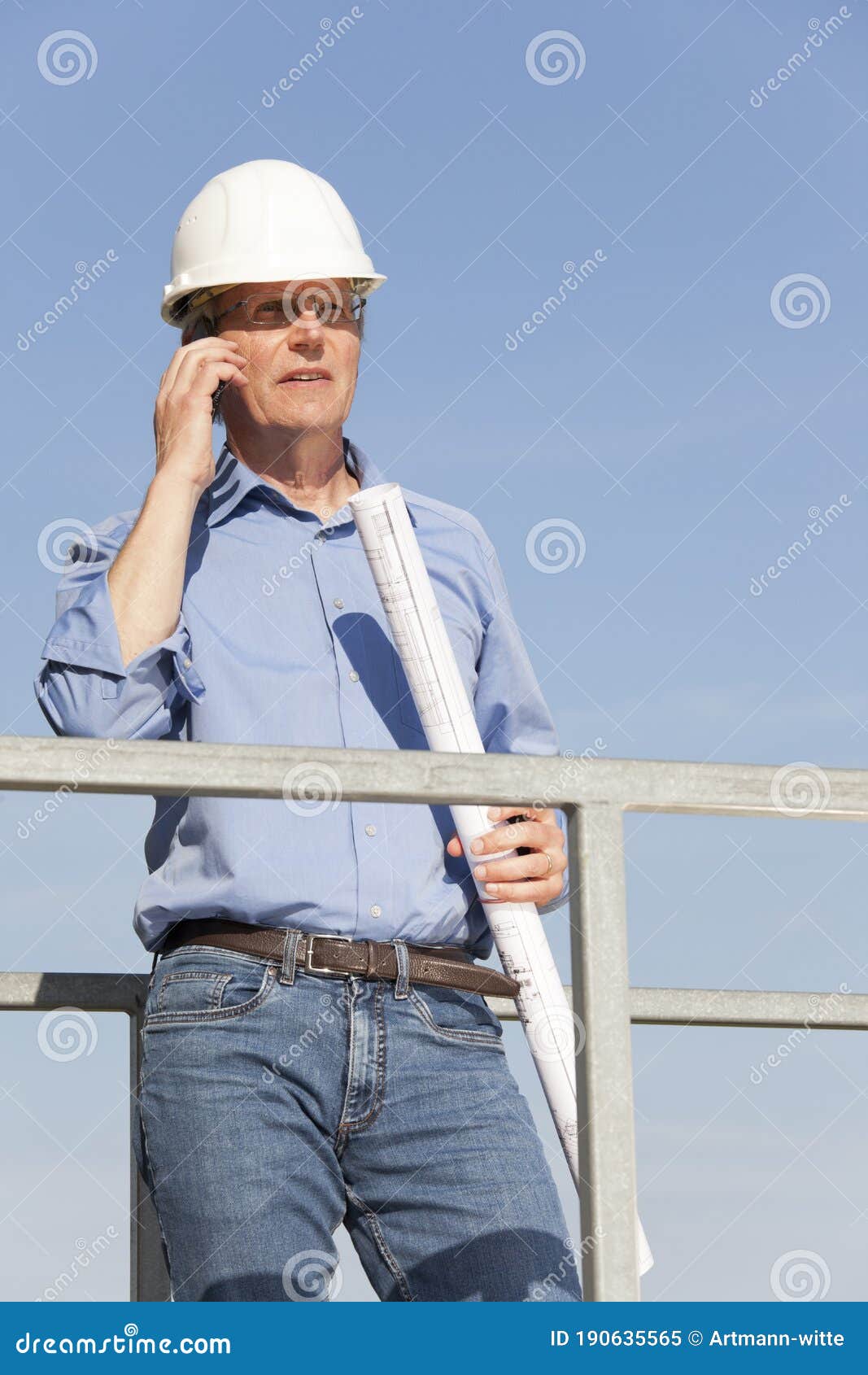 Engineer or Architect with Hard Hat and Blueprint in His Hand on a ...