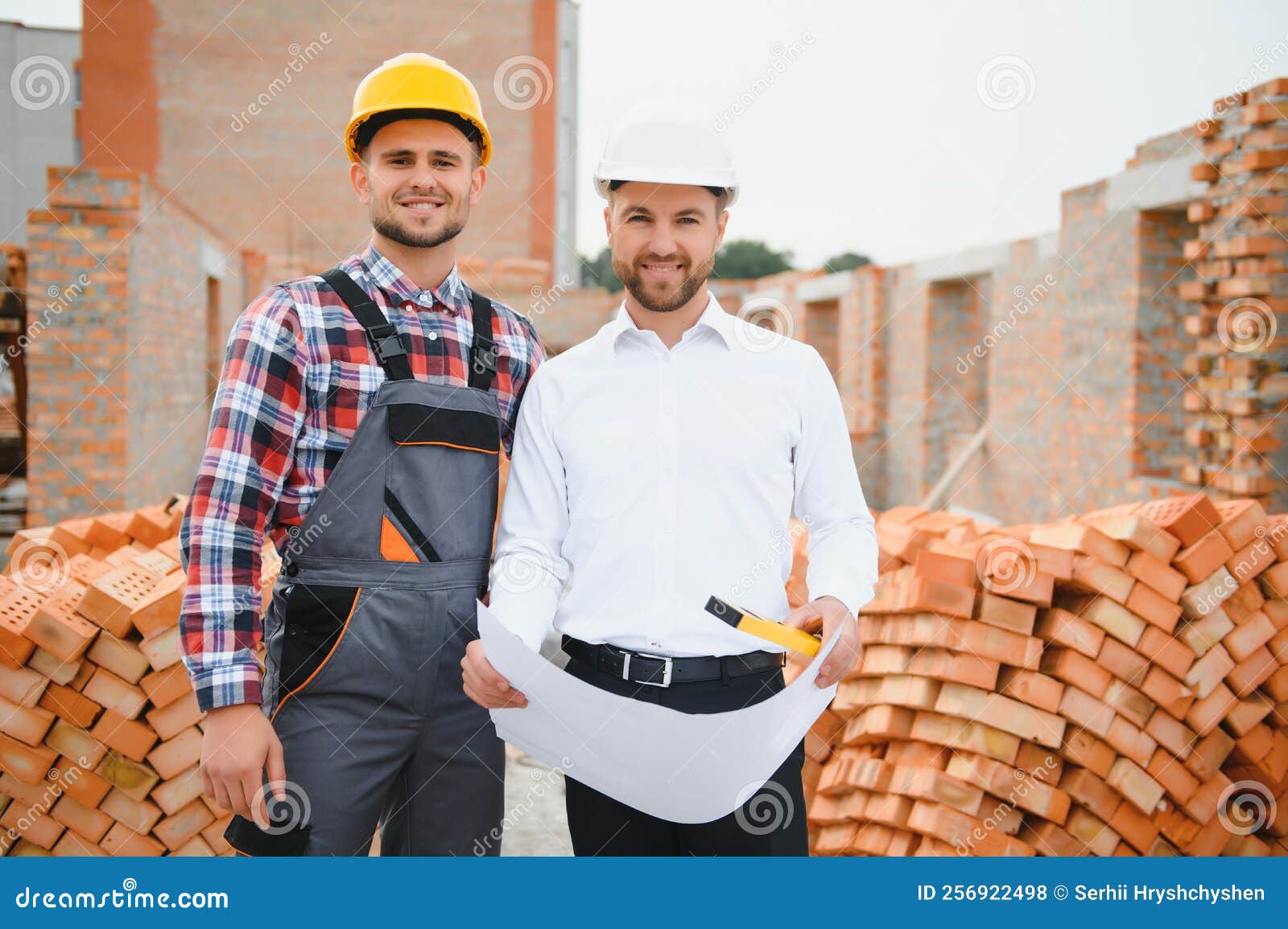 Engineer Architect with Hard Hat and Safety Vest Working Together in ...