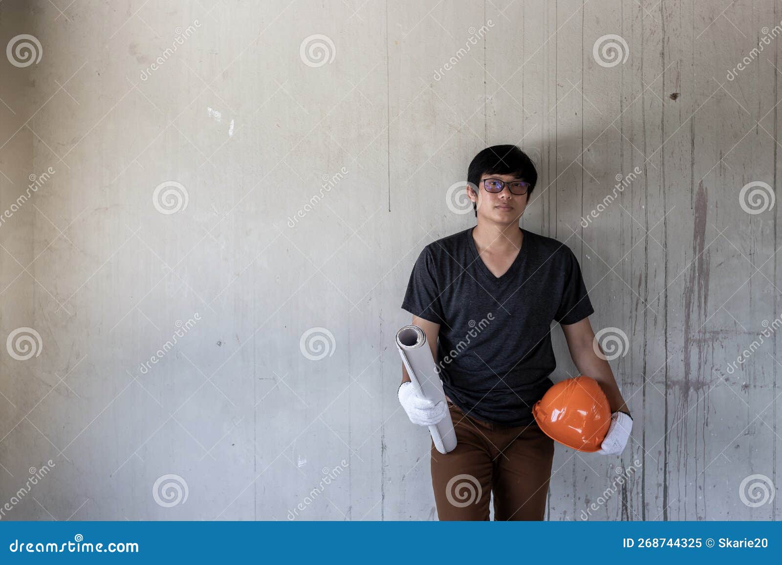 Engineer or Architect Holding Blueprint and Helmet in Building ...