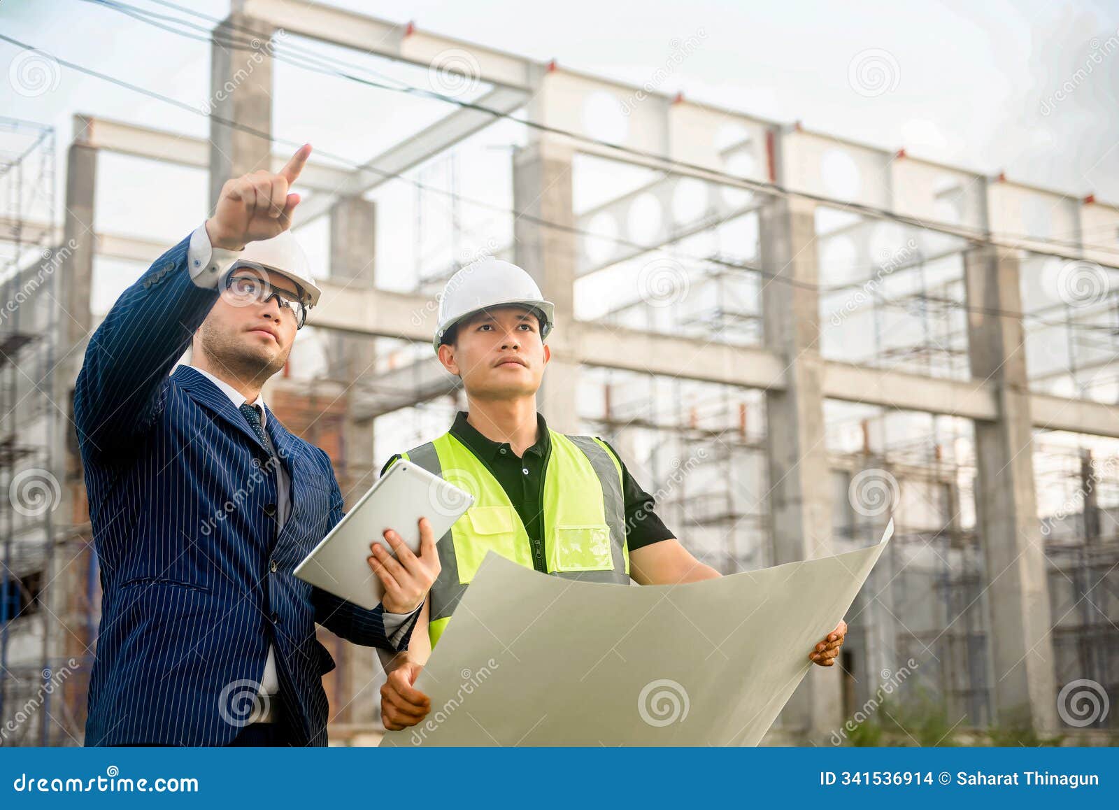 Engineer and Architect Monitor the Progress of Building Construction ...