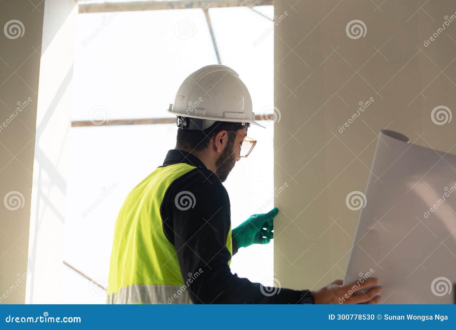 Engineer or Architect Working on the Construction Site, Double-checking ...