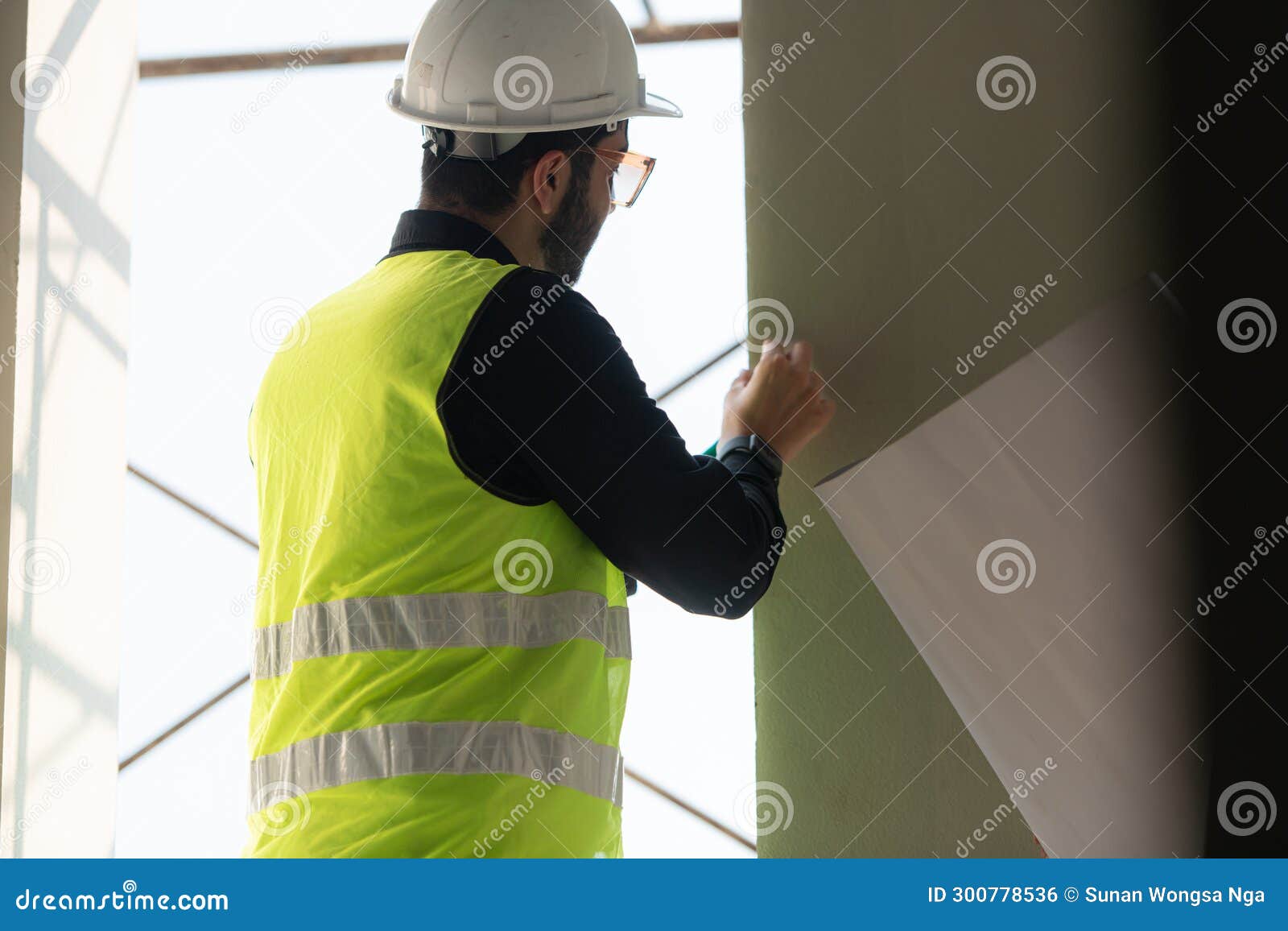 Engineer or Architect Working on the Construction Site, Double-checking ...