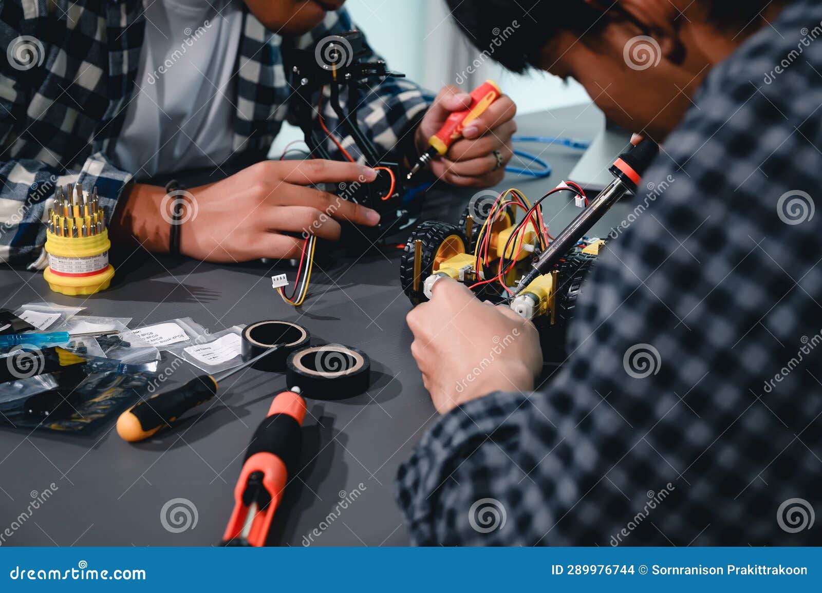 Engineer Asian Students Assembling Robotics Kits. Learning Mechanical Control, Robotics Combines ...