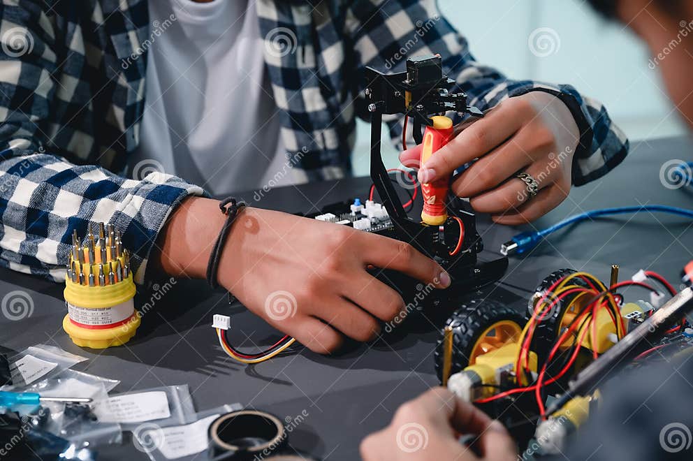 Engineer Asian Students Assembling Robotics Kits. Learning Mechanical Control, Robotics Combines ...