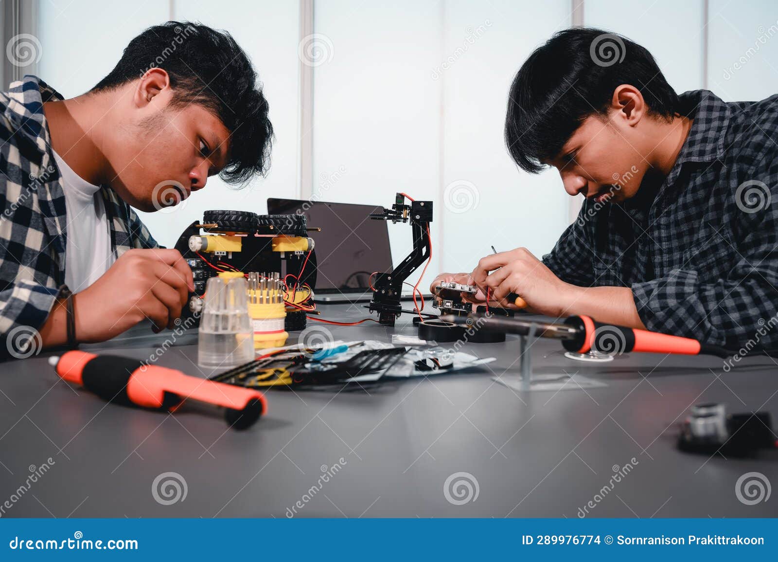 Engineer Asian Students Assembling Robotics Kits. Learning Mechanical Control, Robotics Combines ...
