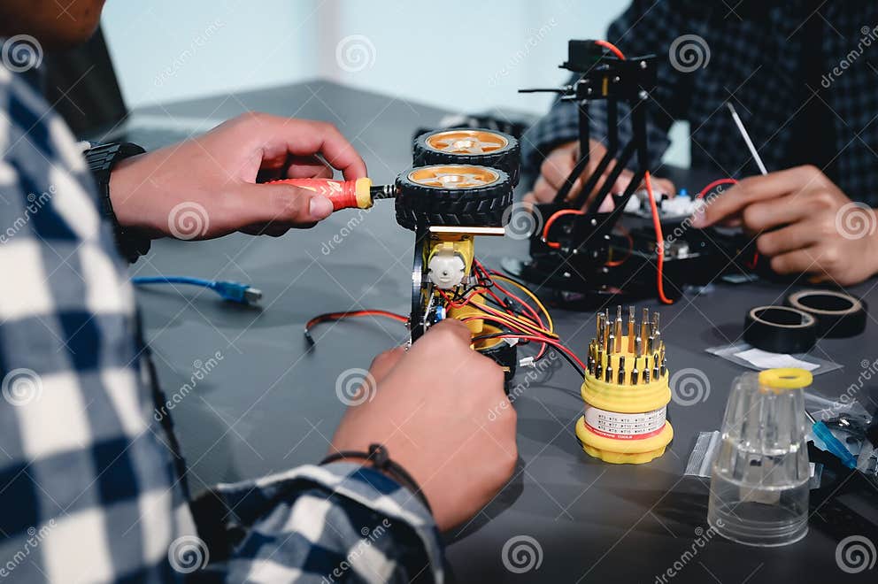 Engineer Asian Students Assembling Robotics Kits. Learning Mechanical ...