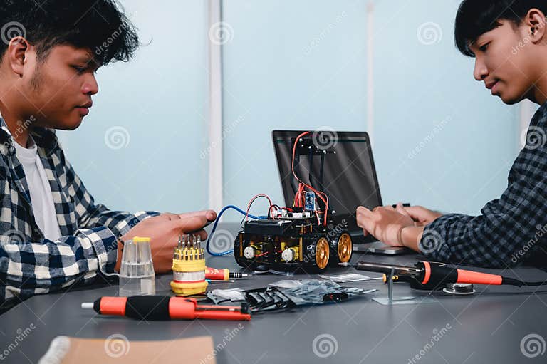 Engineer Asian Students Assembling Robotics Kits. Learning Mechanical Control by Computer ...
