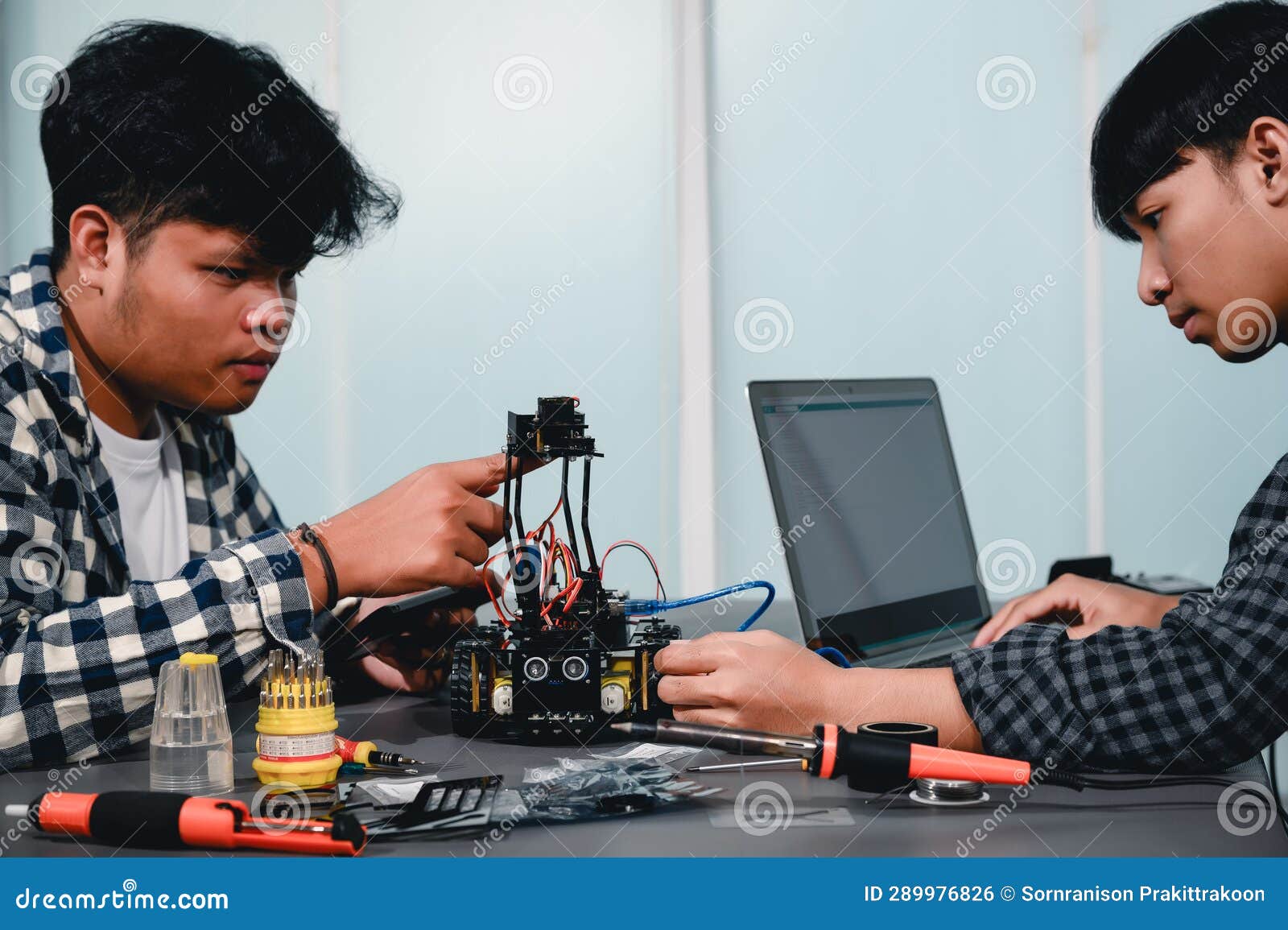 Engineer Asian Students Assembling Robotics Kits. Learning Mechanical ...