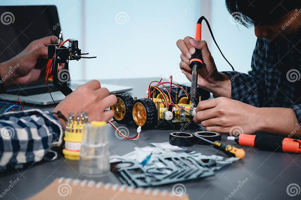 Engineer Asian Students Assembling Robotics Kits. Learning Mechanical ...