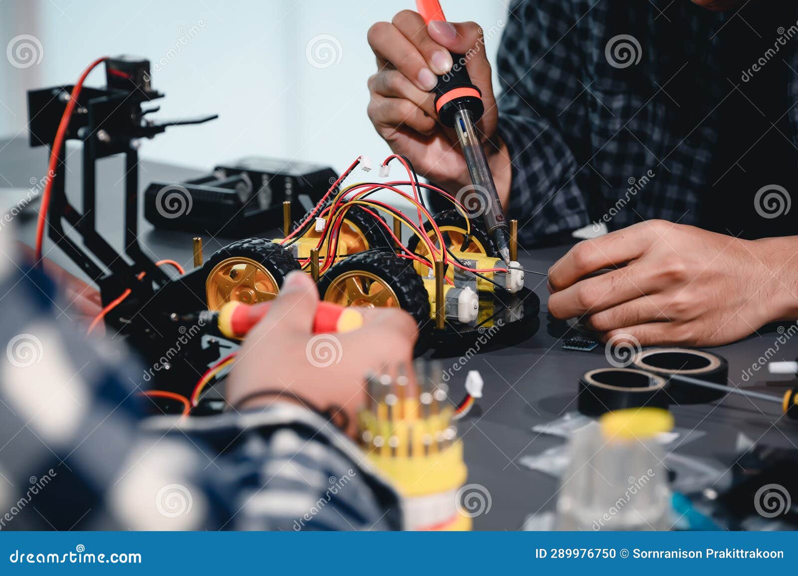 Engineer Asian Students Assembling Robotics Kits. Learning Mechanical ...