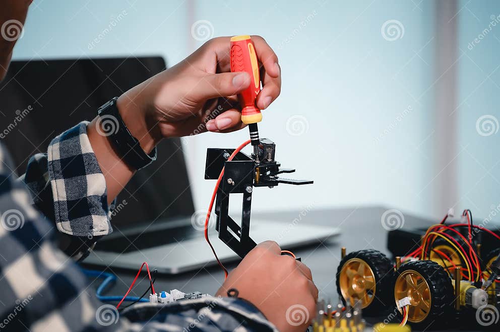 Engineer Asian Students Assembling Robotics Kits. Learning Mechanical ...