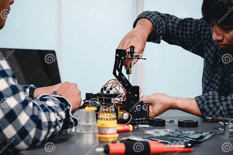 Engineer Asian Students Assembling Robotics Kits. Learning Mechanical ...