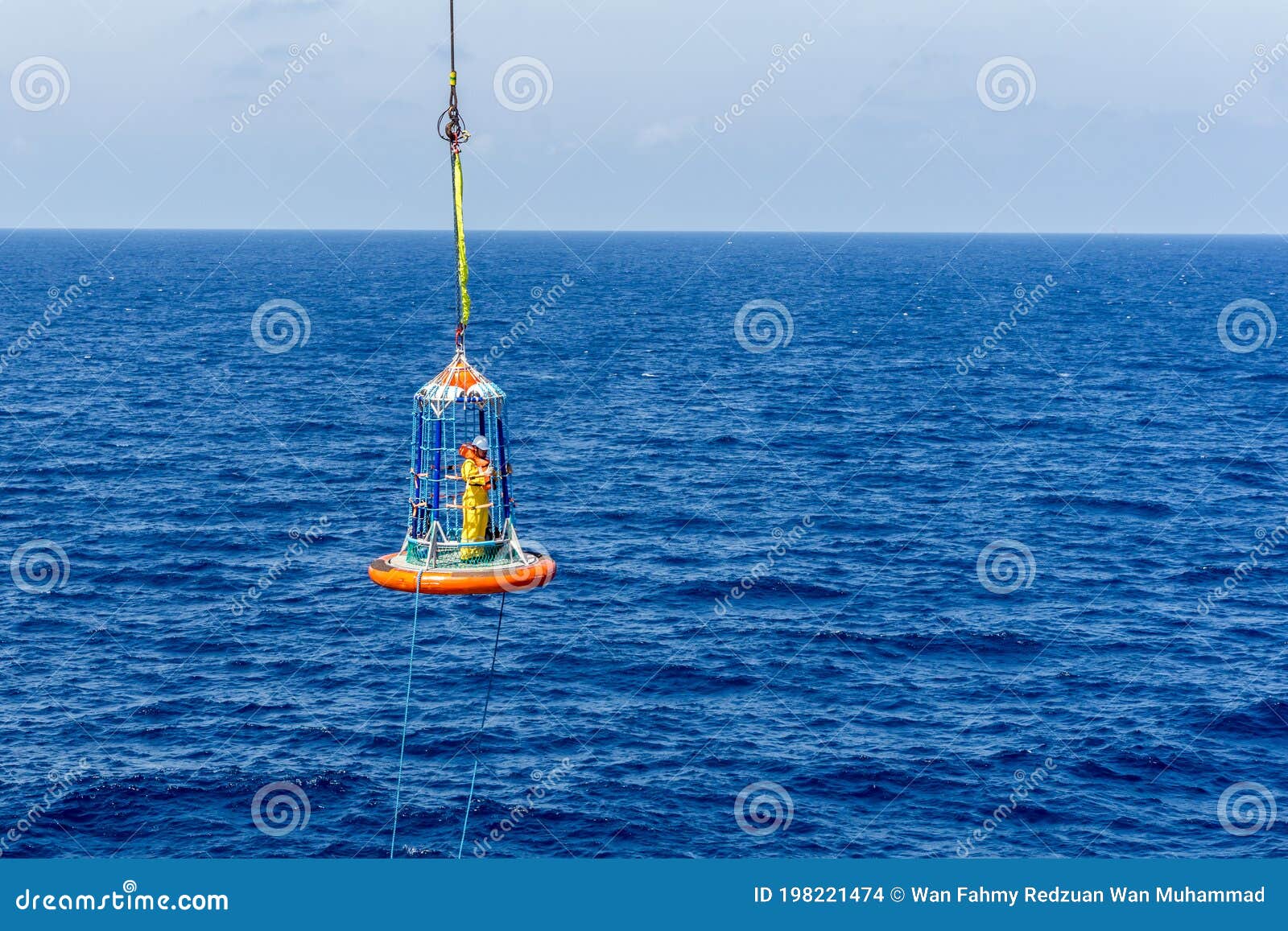 An Engineer Being Transferred from a Boat To a Construction Work Barge ...