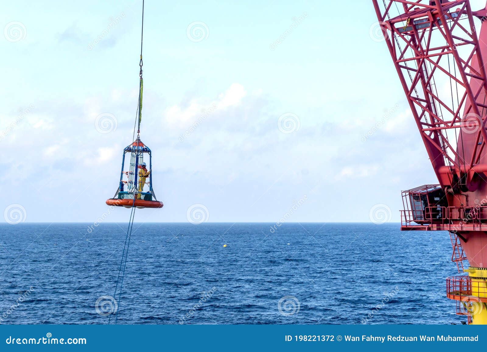 An Engineer Being Transferred from a Boat To a Construction Work Barge ...