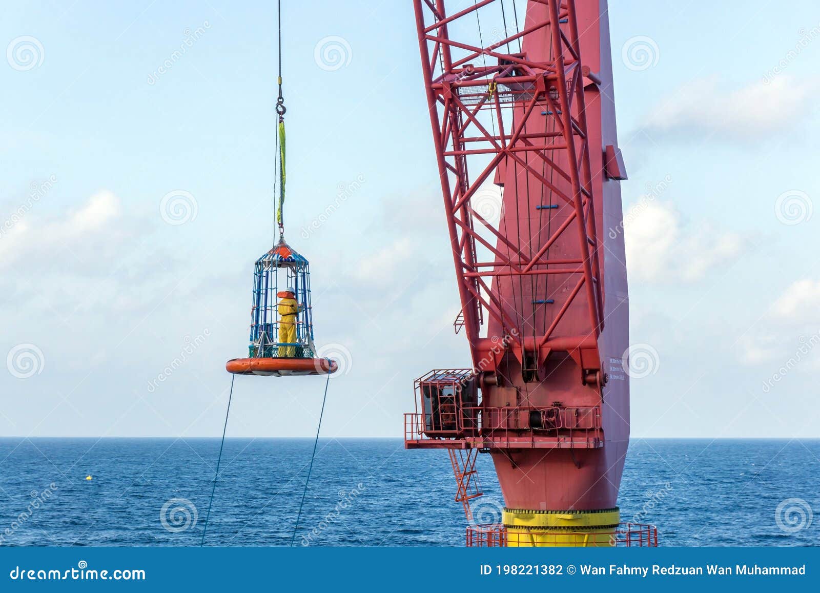An Engineer Being Transferred from a Boat To a Construction Work Barge ...