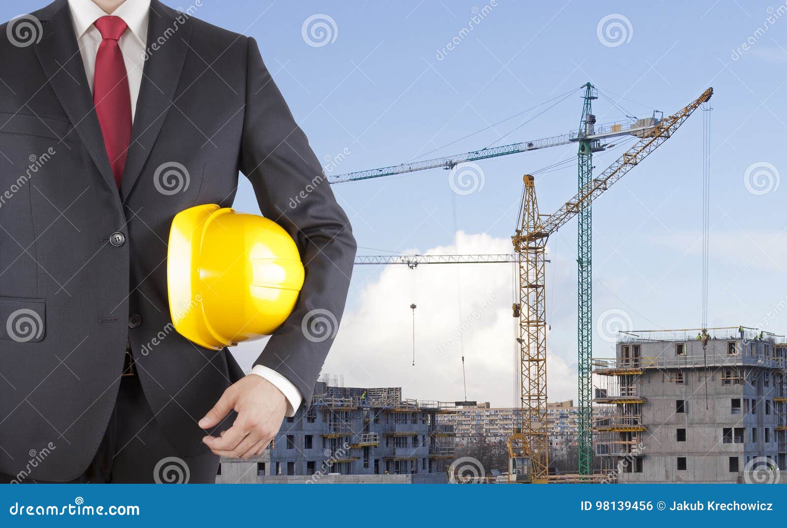 Engineer in Black Suit Holding Yellow Helmet on Construction Site Stock ...