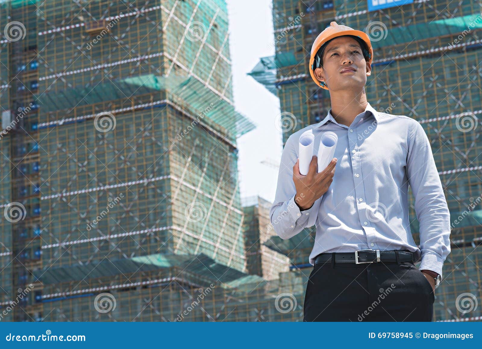 Engineer with blueprints stock image. Image of safety - 69758945