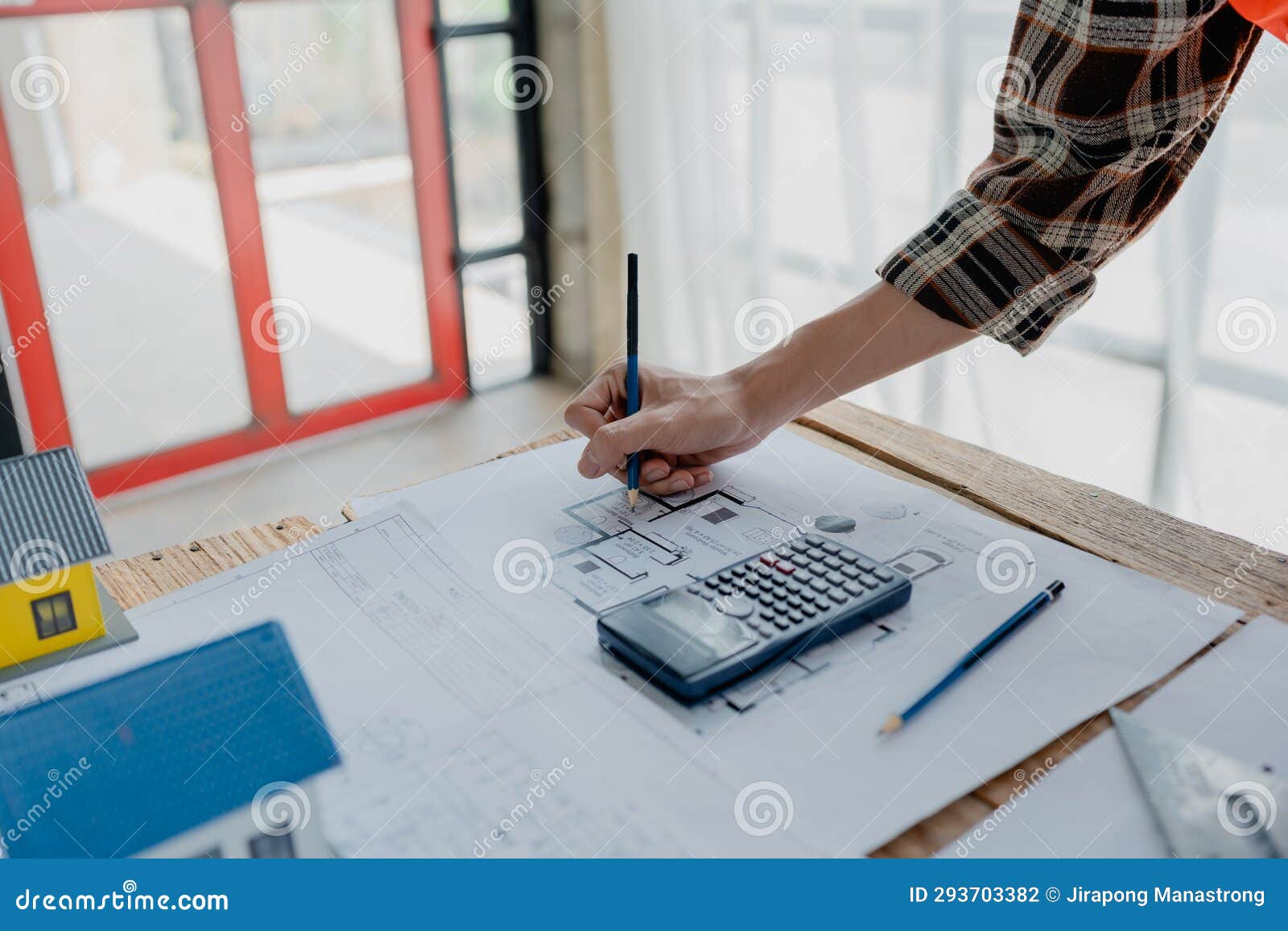 Engineer Brainstorming and Measuring for Cost Estimating on Blueprint ...